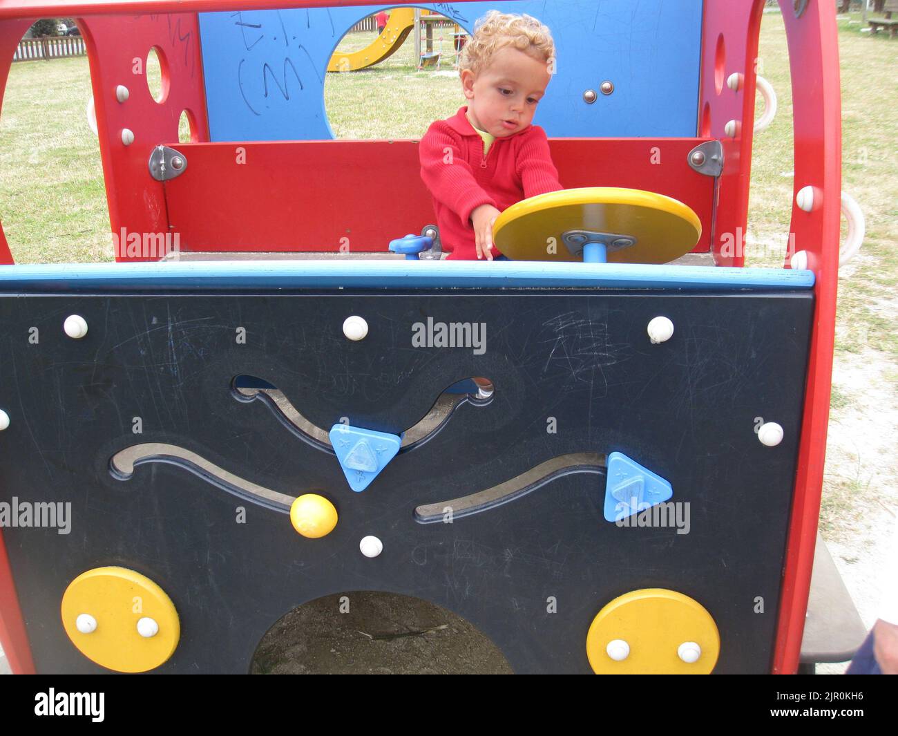 my two year old son driving a wooden car in the playground Stock Photo ...