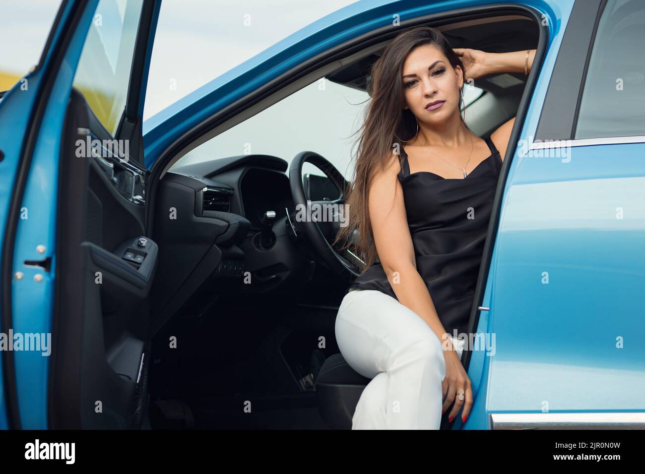 Successful lady driver demonstrates confident pose in car Stock Photo ...