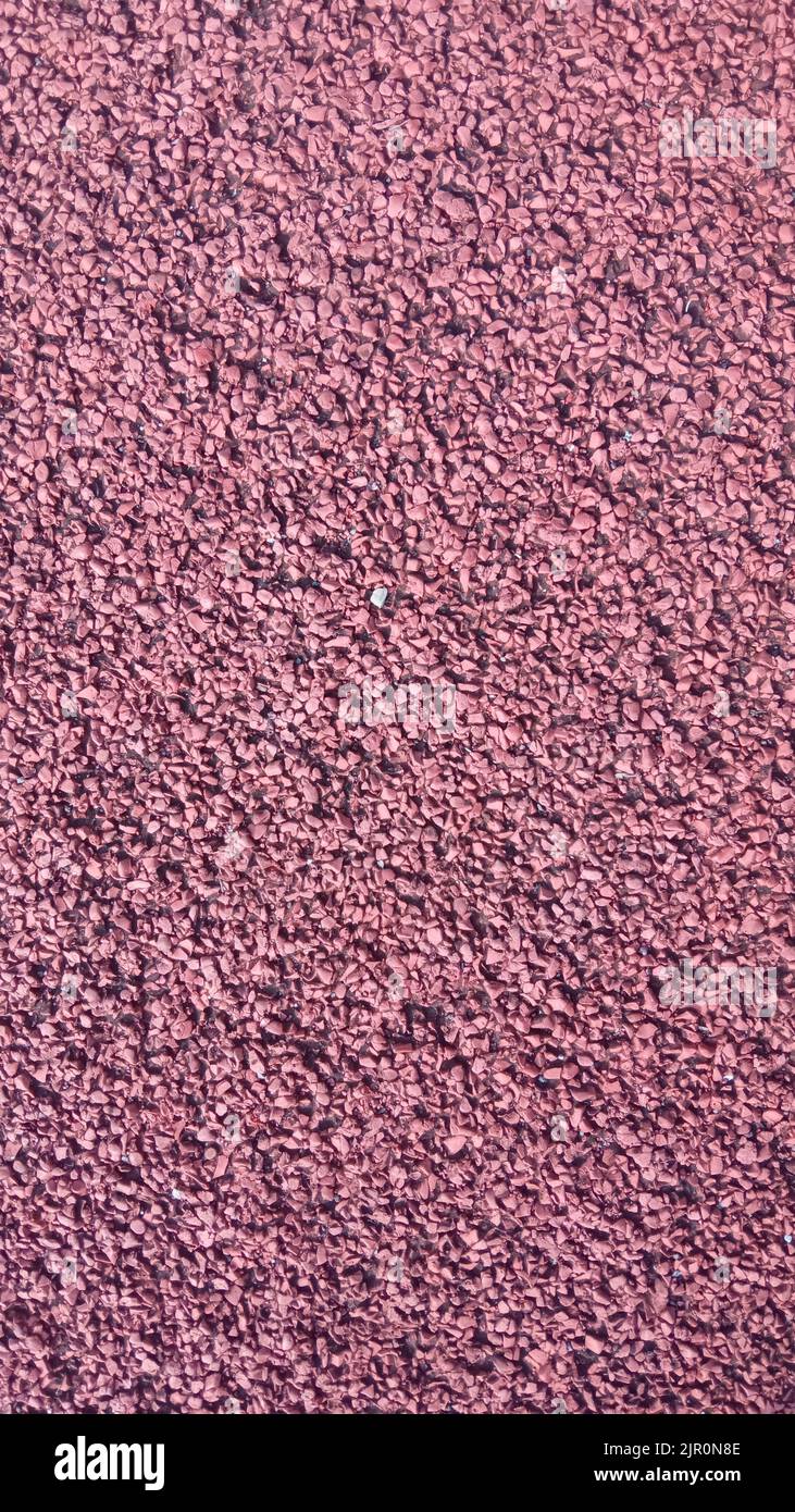 A vertical closeup of red pebbled ground - great for wallpapers or ...