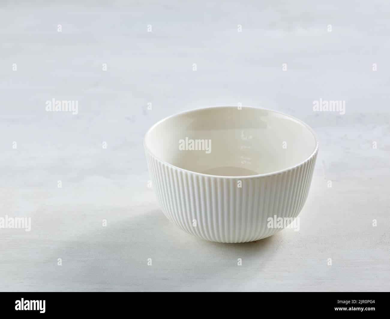 empty white bowl on white kitchen table Stock Photo - Alamy