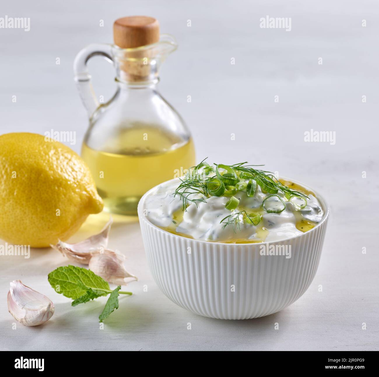 bowl of sour cream or greek yogurt tzatziki sauce decorated with ...