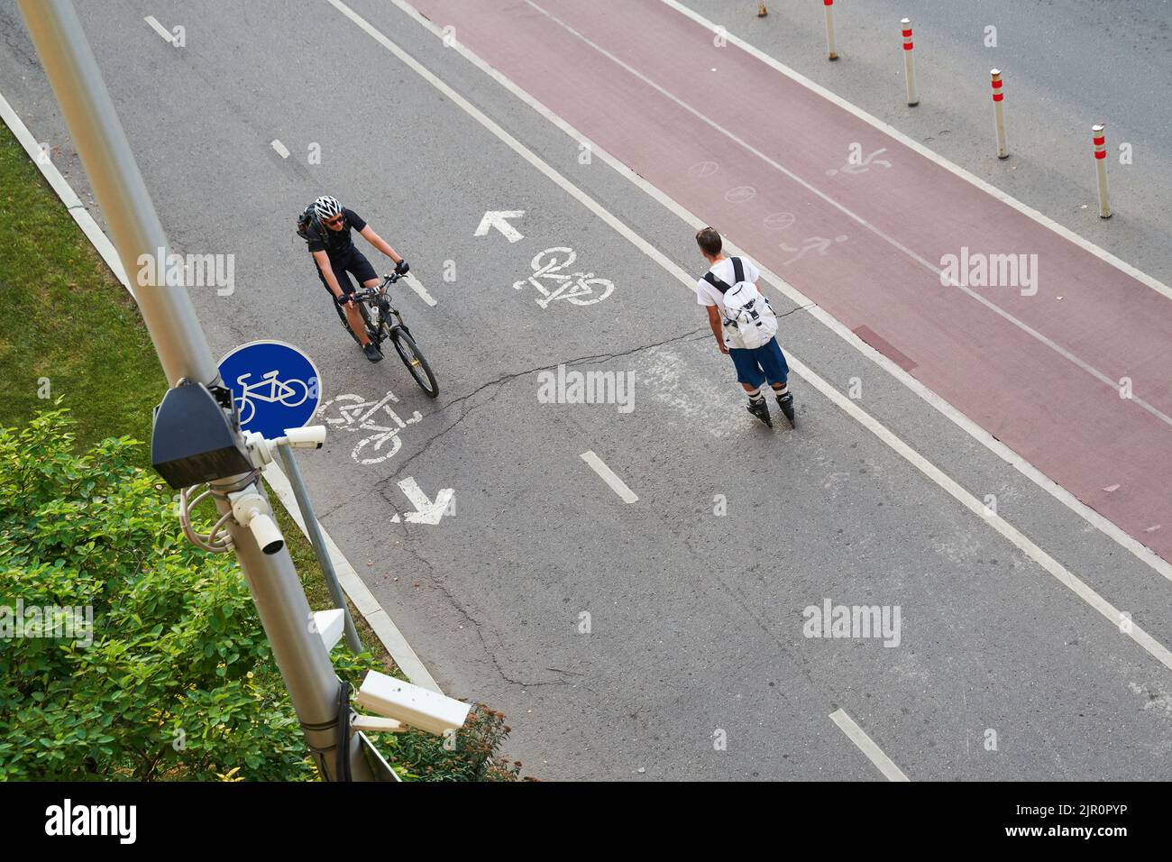 Top aerial view of cyclist and inline skater on cycling road. Concept ...