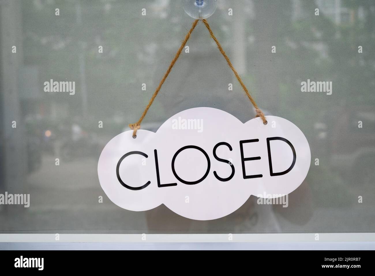 Closed label on the cloud-shaped board, hanging behind the glass door ...