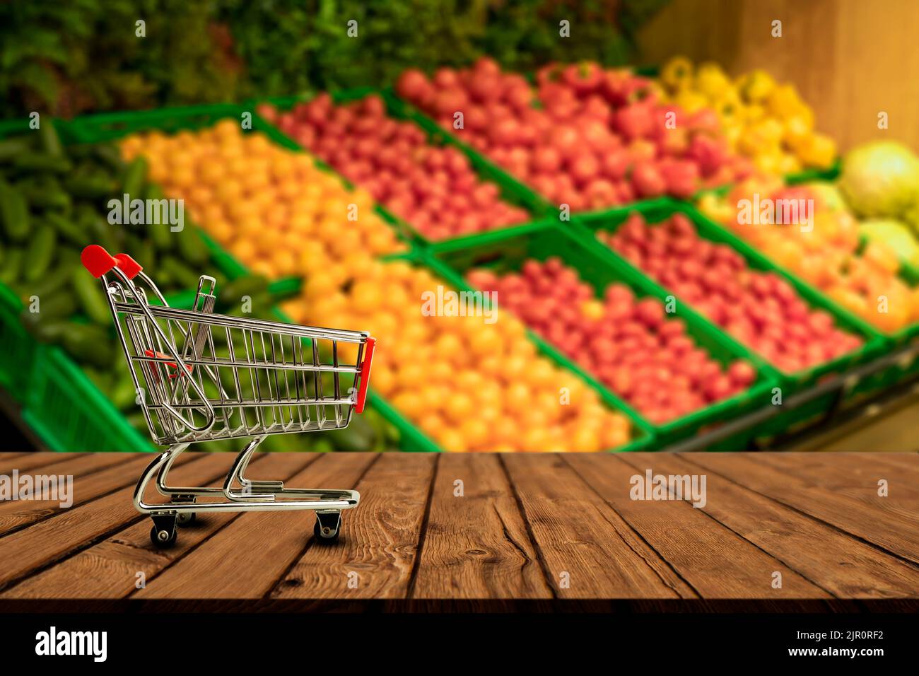 Supermarket table background. A counter with blurred vegetables and ...