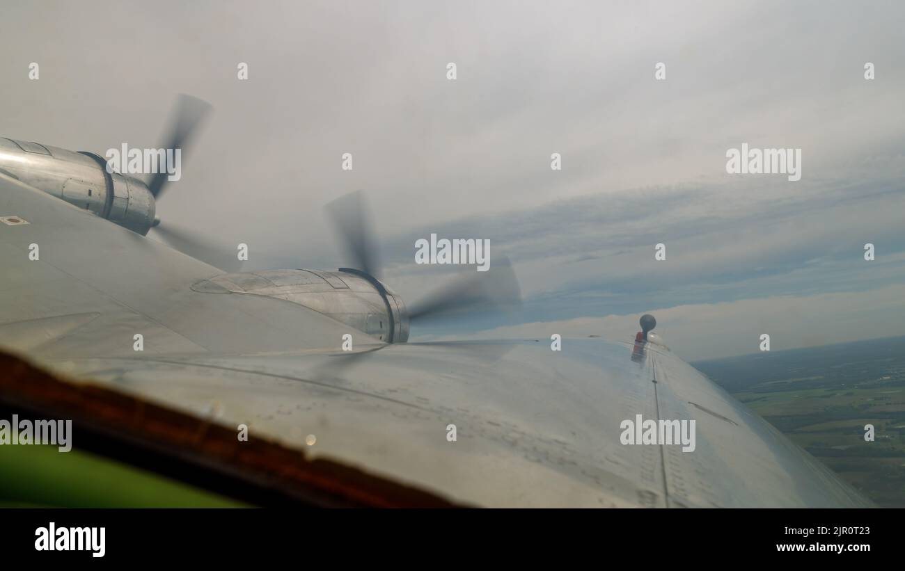 The airplane wing with two propellers during flight Stock Photo - Alamy