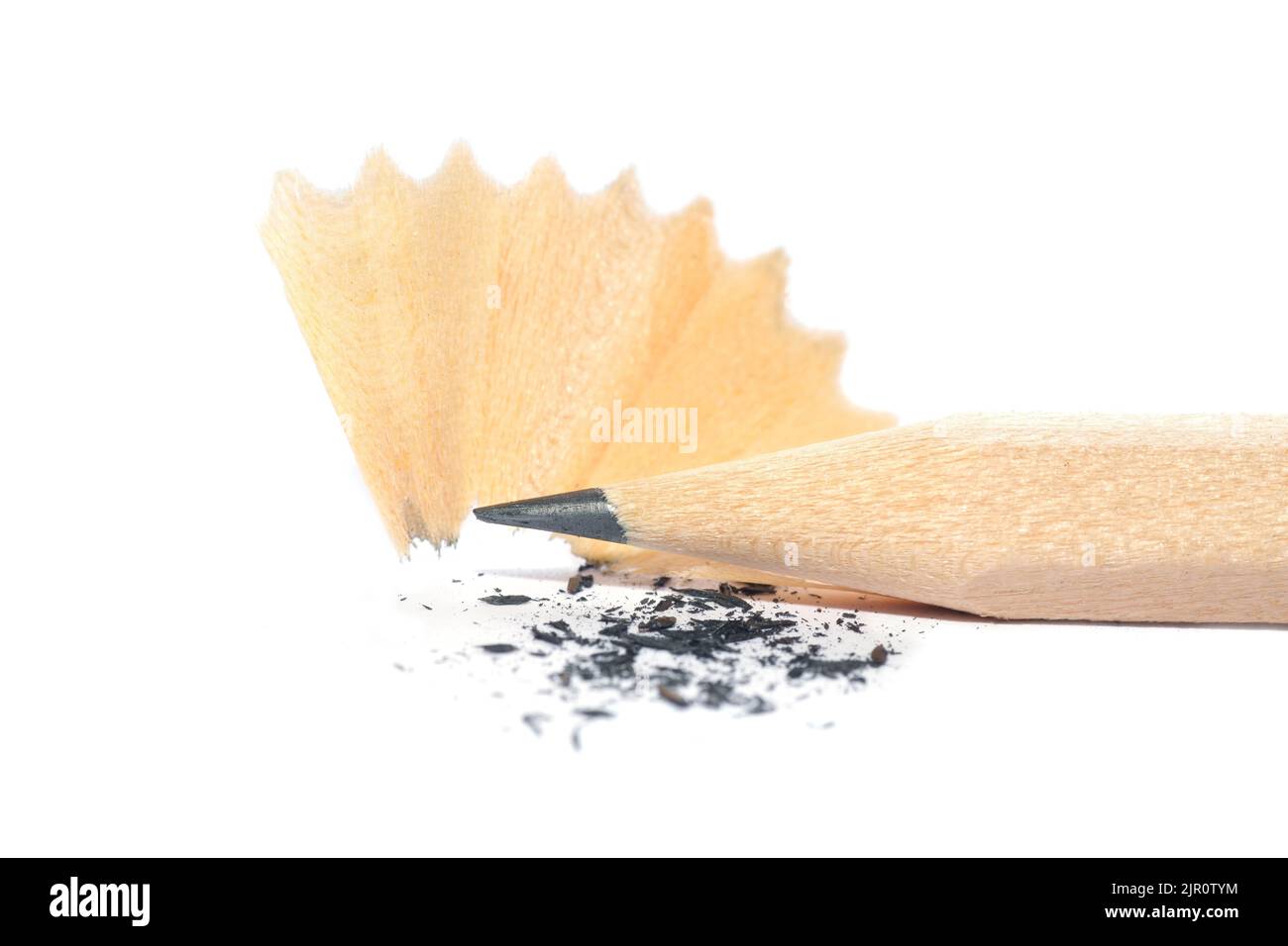 Graphite pencil tip close-up with sharpening shavings on white ...