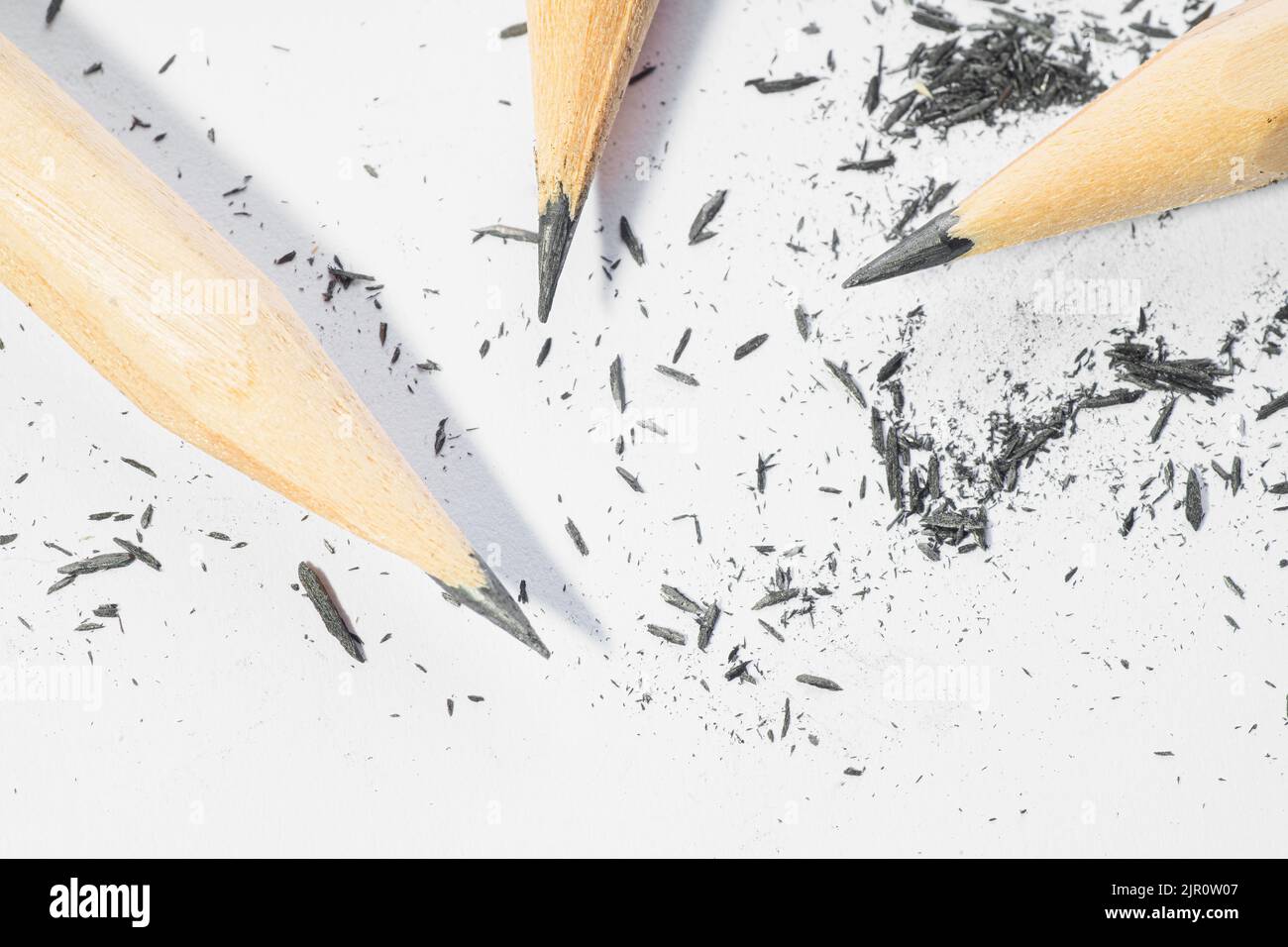 Three sharpened pencils with lead shavings on white background Stock ...