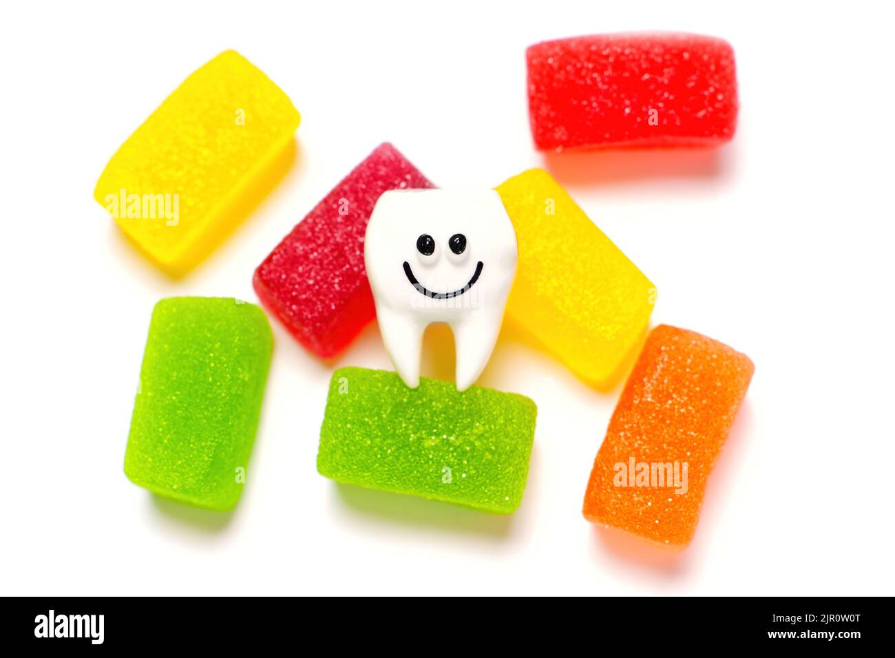 Funny tooth character and a bunch of colorful jelly candies isolated on ...