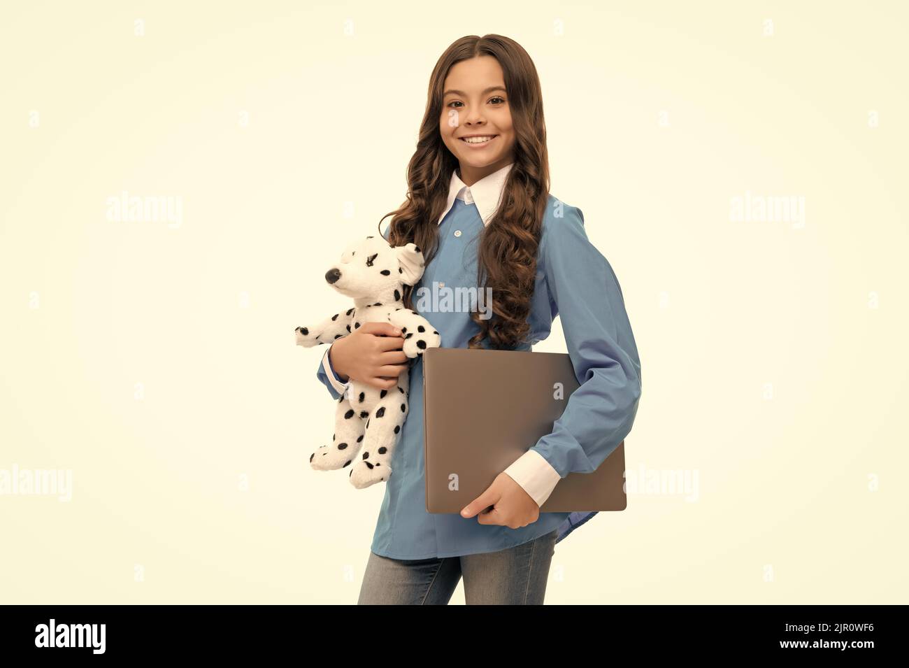 happy face of teen girl with long curly hair hold computer and toy ...