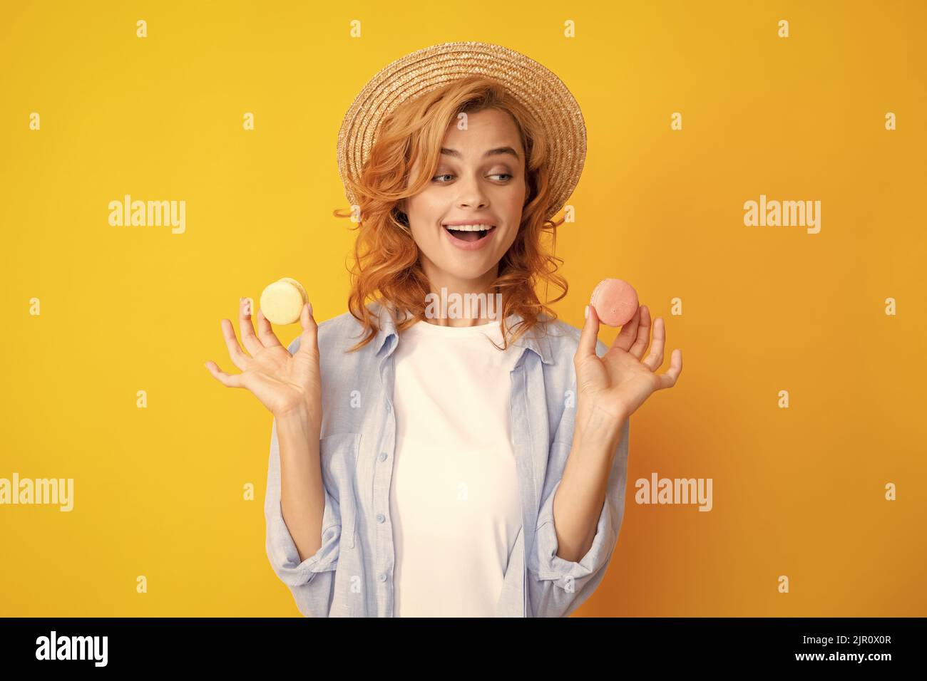 Beauty model girl taking colorful macaroons. Beautiful woman eating ...