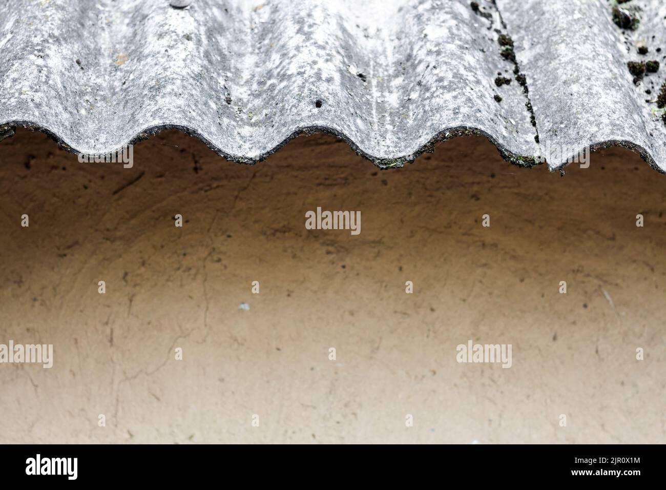 Closeup of old slate roof over a clay wall. Copy space, shallow depth ...