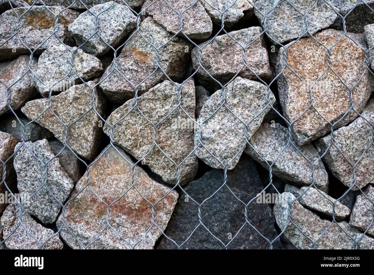Gabion wall closeup. Textured background. Gabion is stones in wire mesh ...