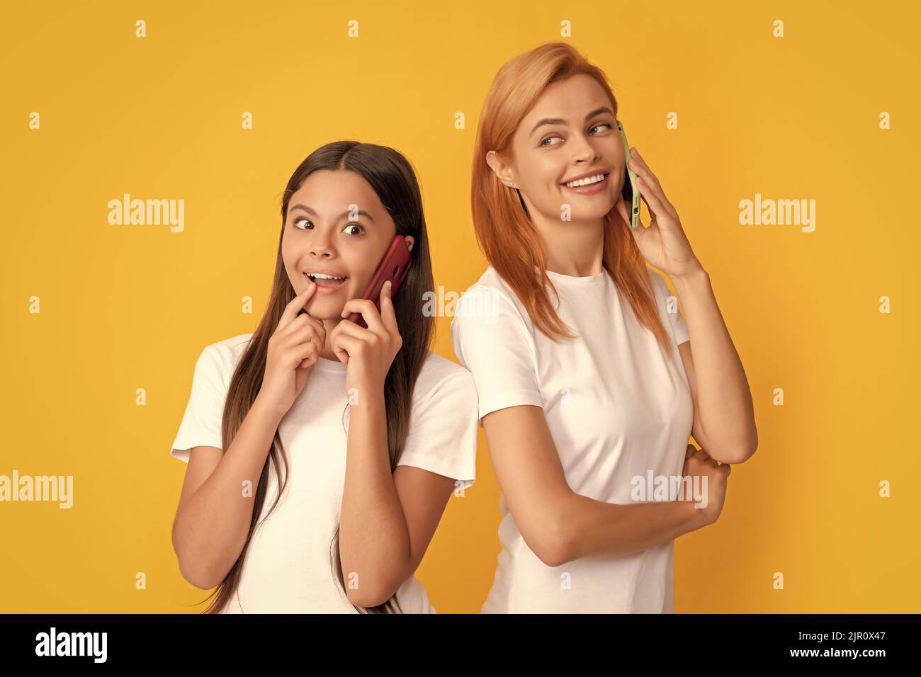 mother and daughter speaking using modern smartphone, communication ...