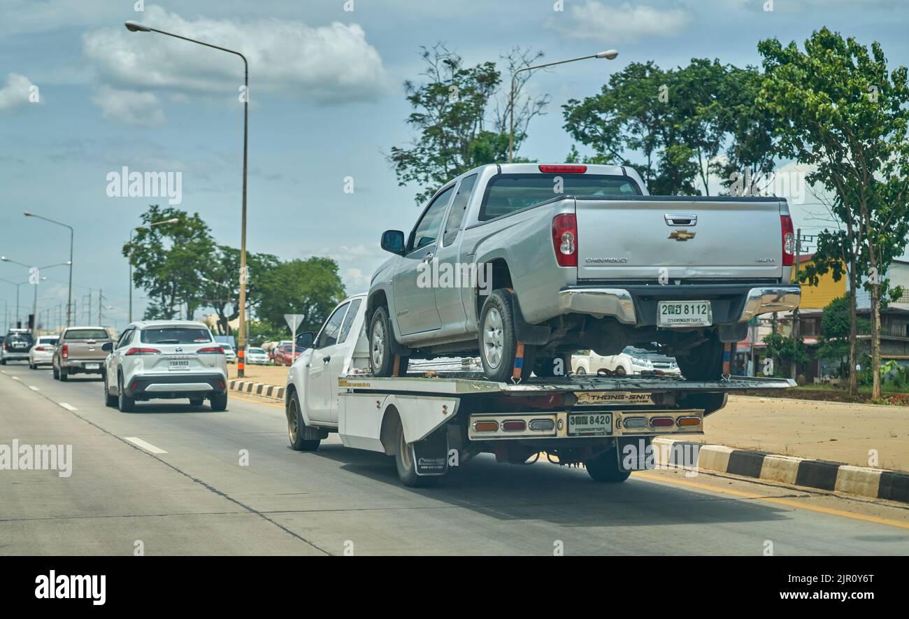 A pickup truck being transported on a flat bed transporter truck, taken ...