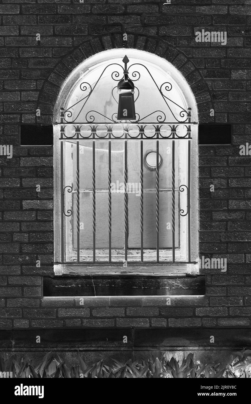 Fancy and ornate wrought iron security grating on a huge window in a ...