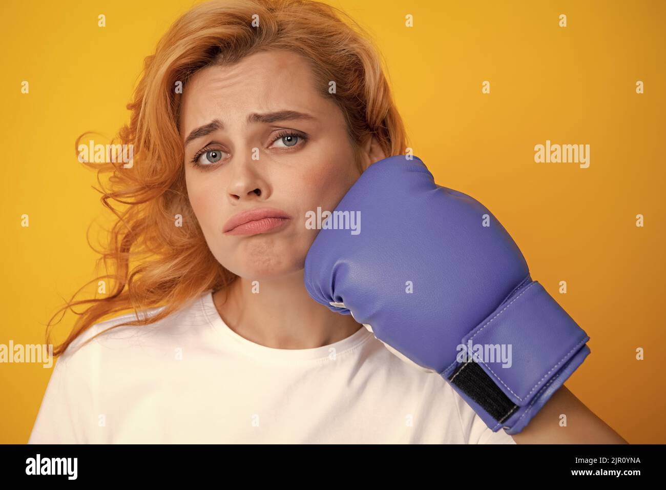 Funny woman with boxing gloves with punching face isolated on yellow ...