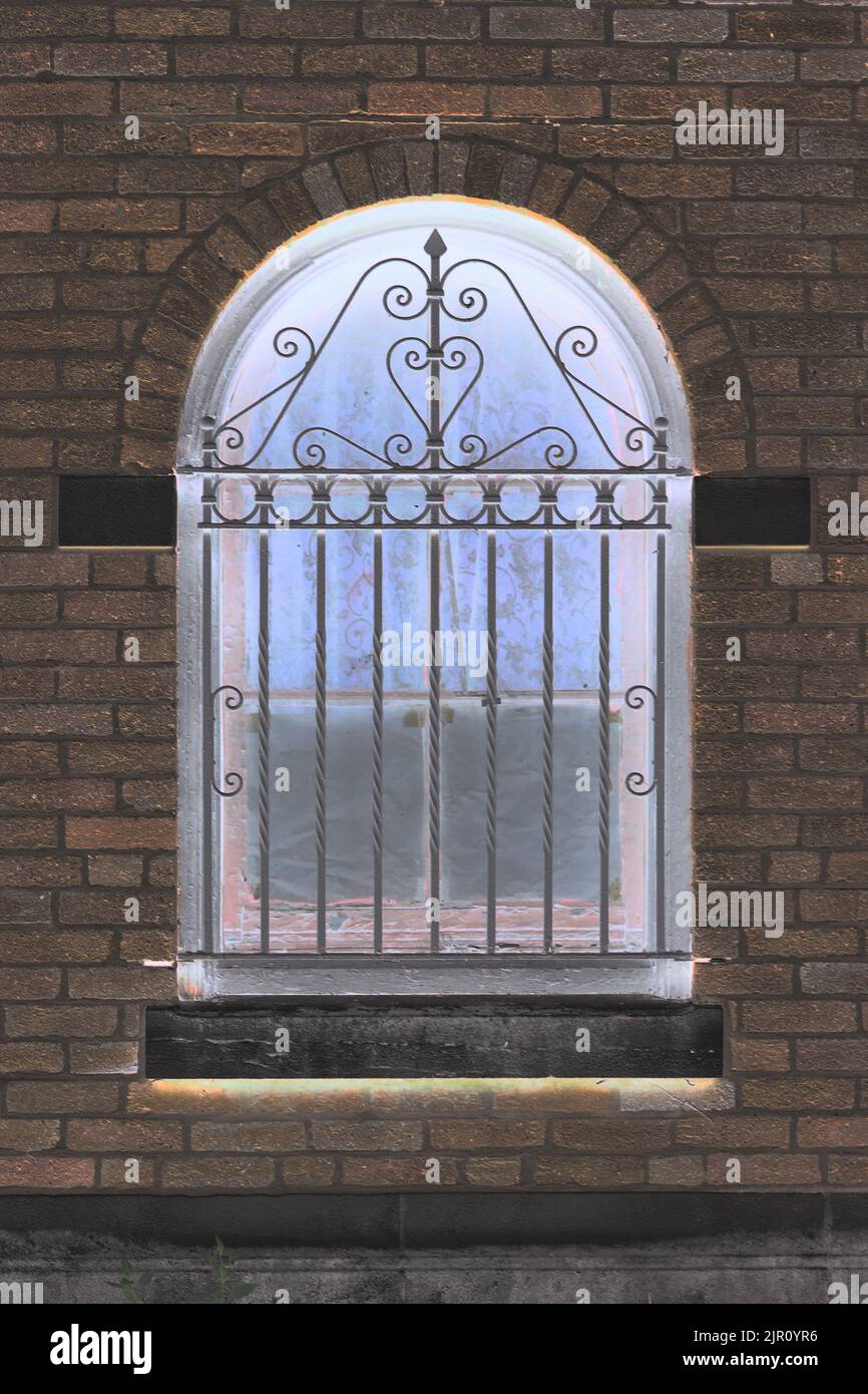 Fancy and ornate wrought iron security grating on a huge window in a ...