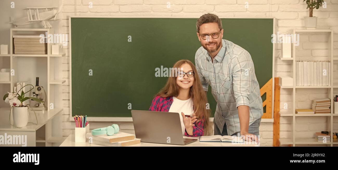 private teacher and child at computer. family help. dad and daughter ...