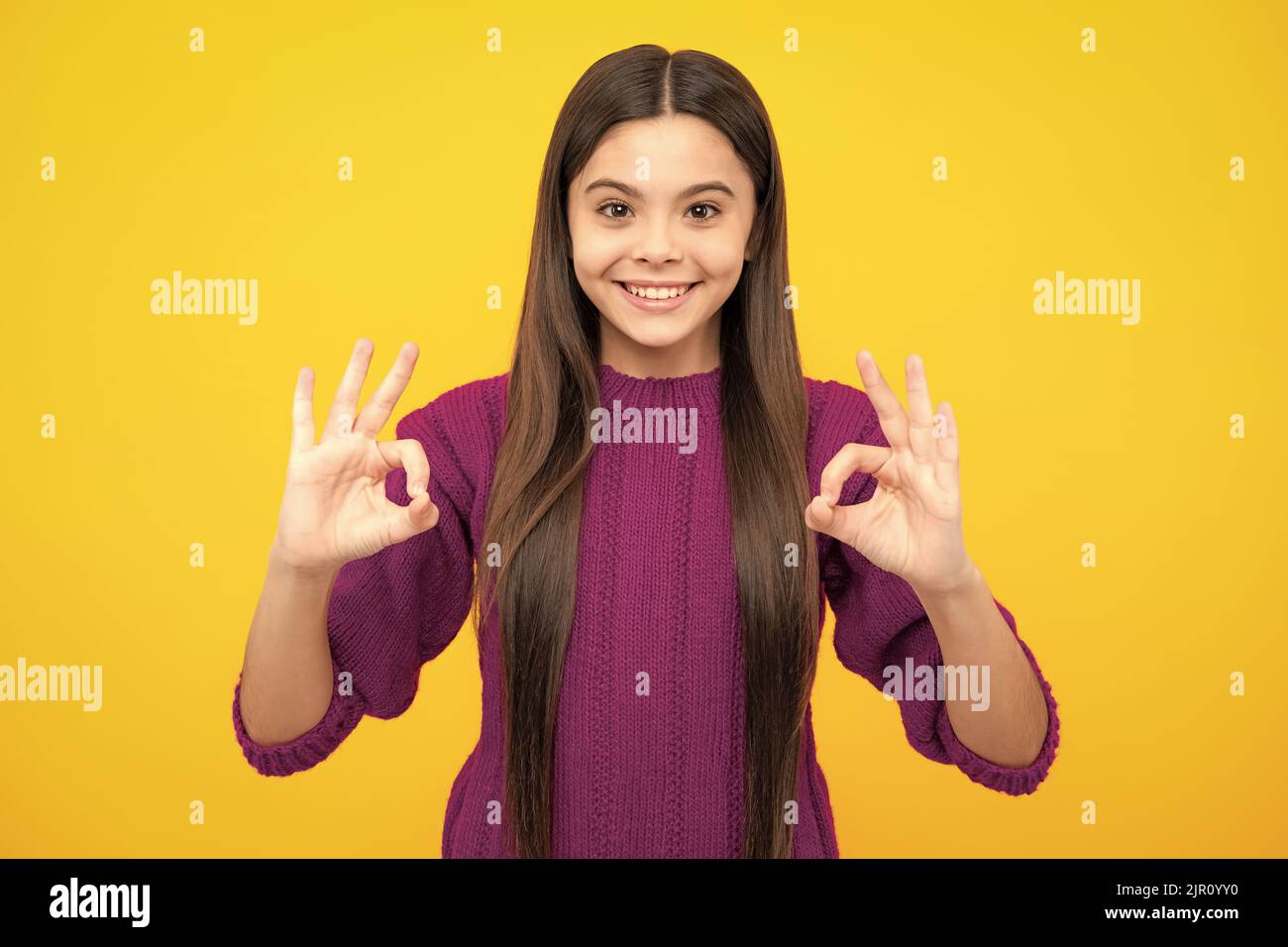 Beautiful child girl making ok sign on yellow background. Portrait of ...