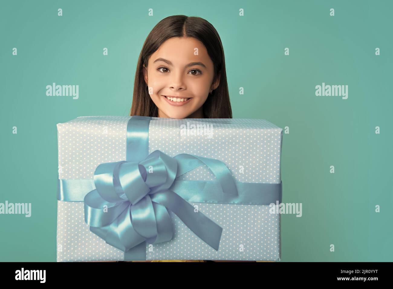 Happy girl face, positive and smiling emotions. Child with gift present ...