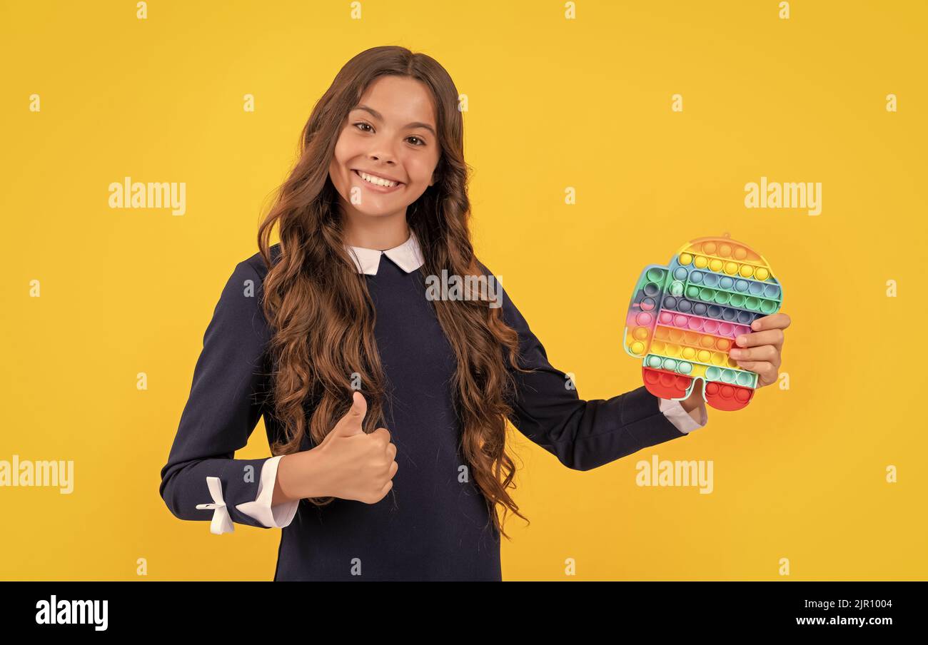 happy teen girl play with popit silicone sensory fidget toy with thumb ...