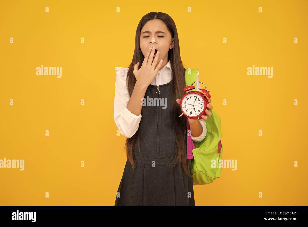 Back to school. Teenager schoolgirl with bag hold clock alarm, time to ...
