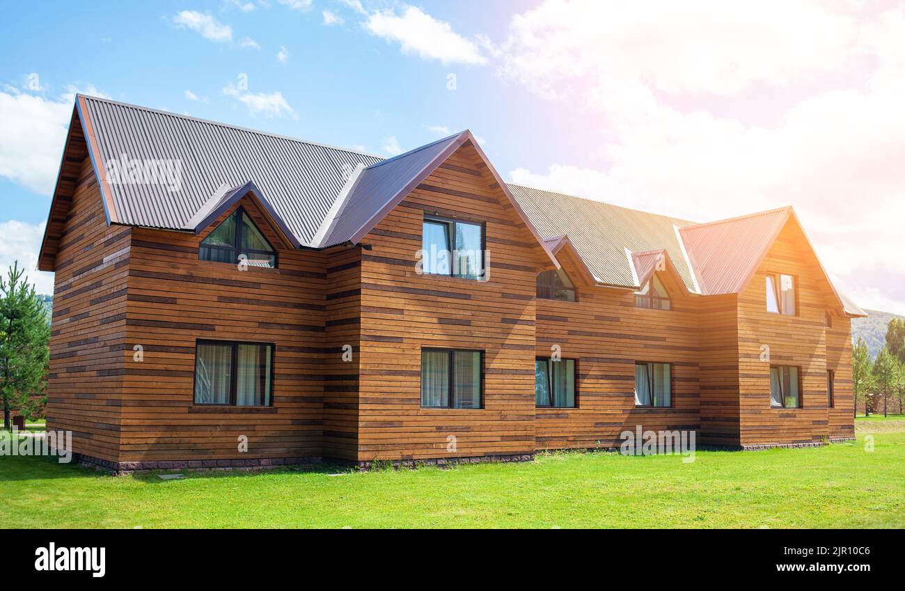 Two-storey wooden cottage with windows nature with a green lawn. Sale ...