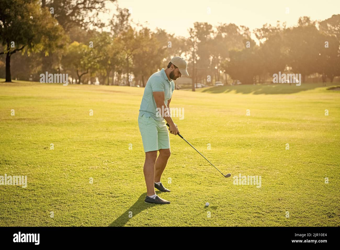 male golf player on professional golf course. portrait of golfer in cap ...