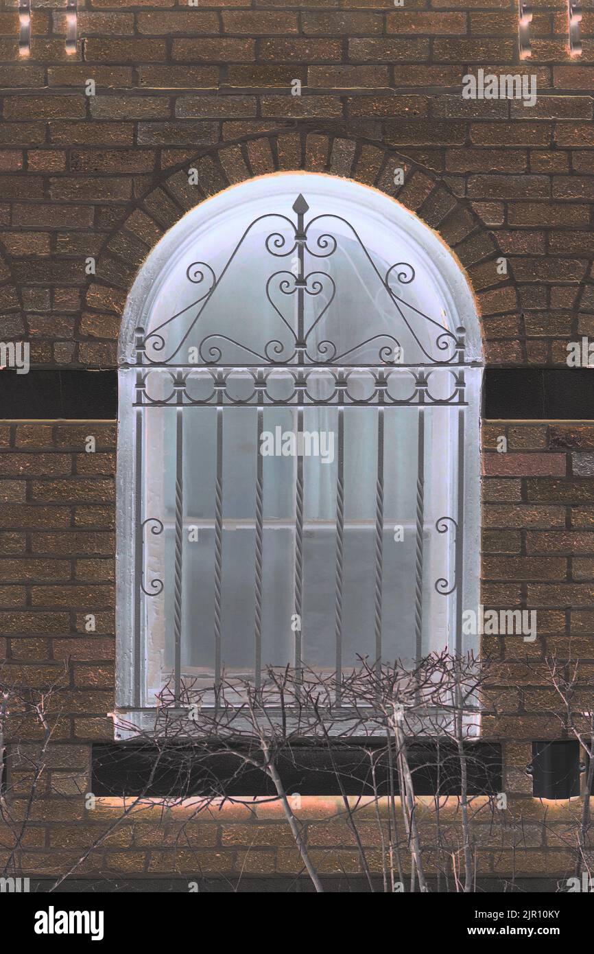 Fancy and ornate wrought iron security grating on a huge window in a ...