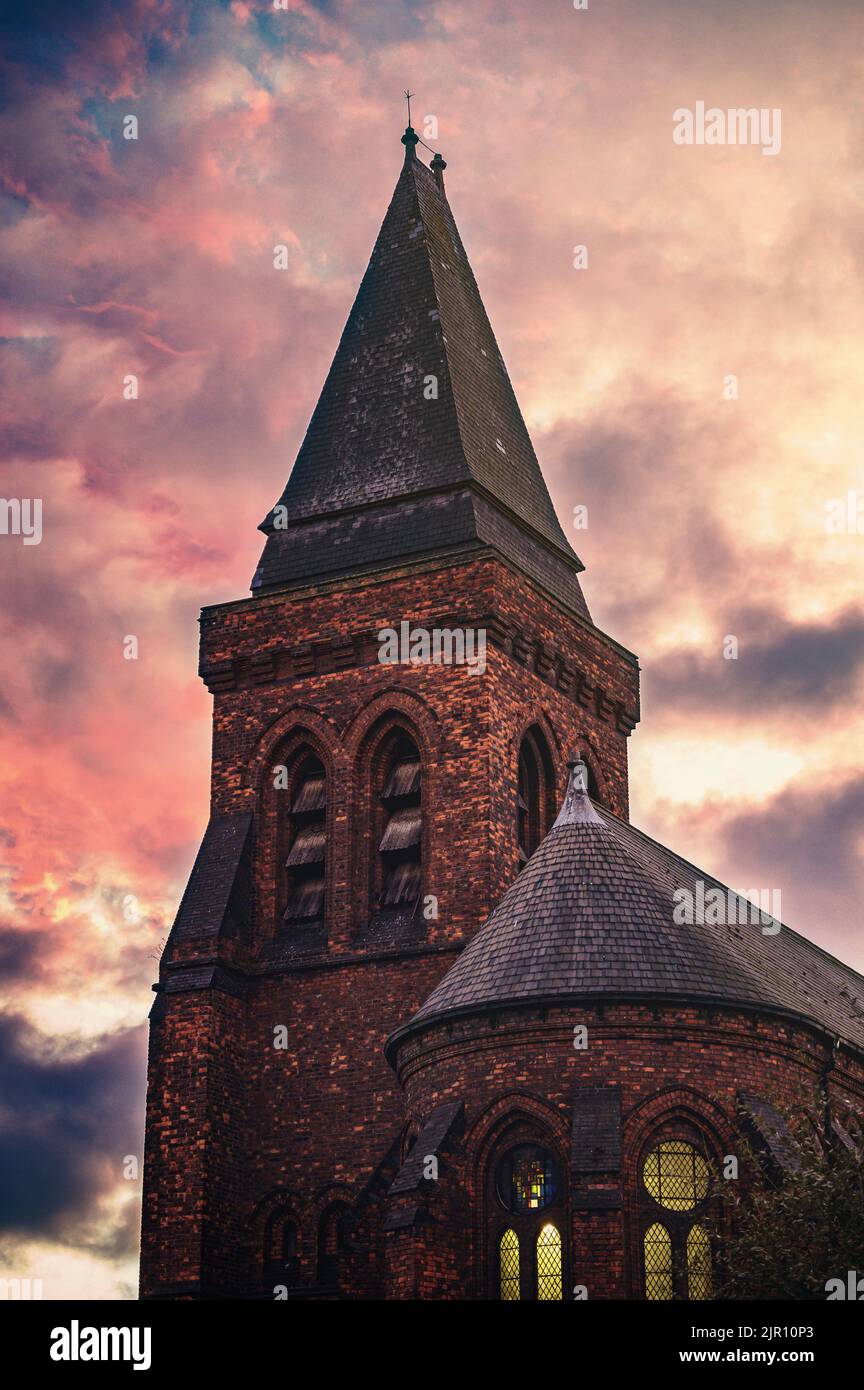A vertical shot of a cathedral on a colorful cloud background Stock ...