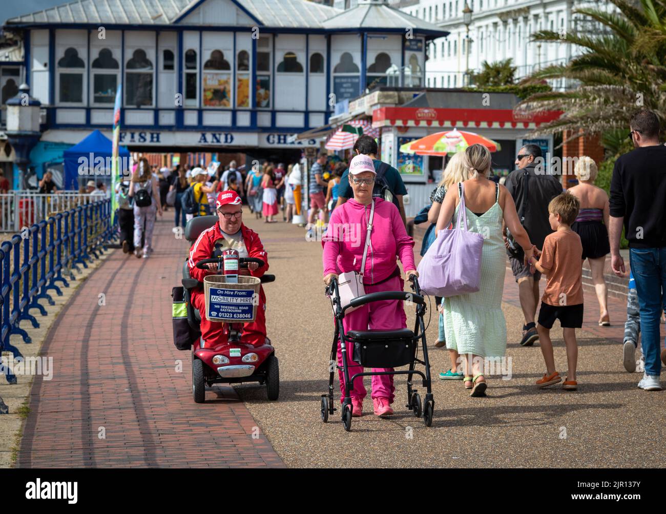 A disabled couple use a mobility scooter and a rollator on the ...