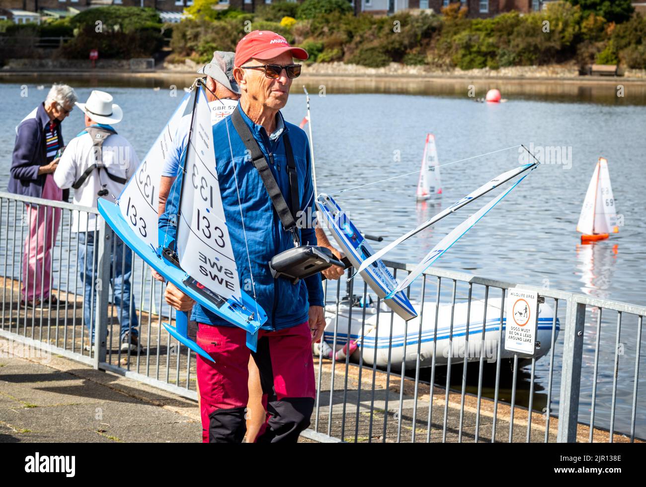 A Swewdish competitor carries his radio-controlled yacht after ...