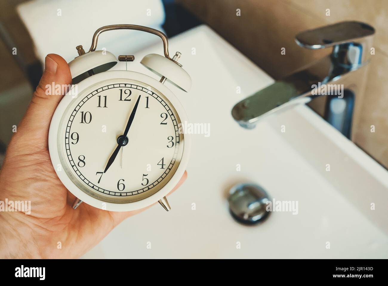 The clock shows 7 am. Time to wash up and brush your teeth Stock Photo ...