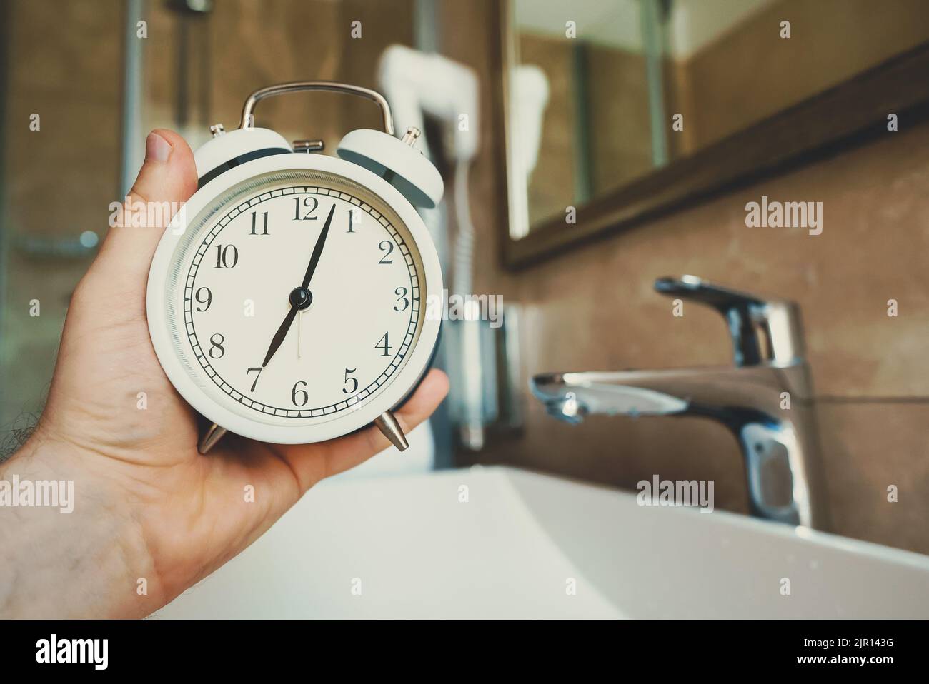 The clock shows 7 am. Time to wash up and brush your teeth Stock Photo ...