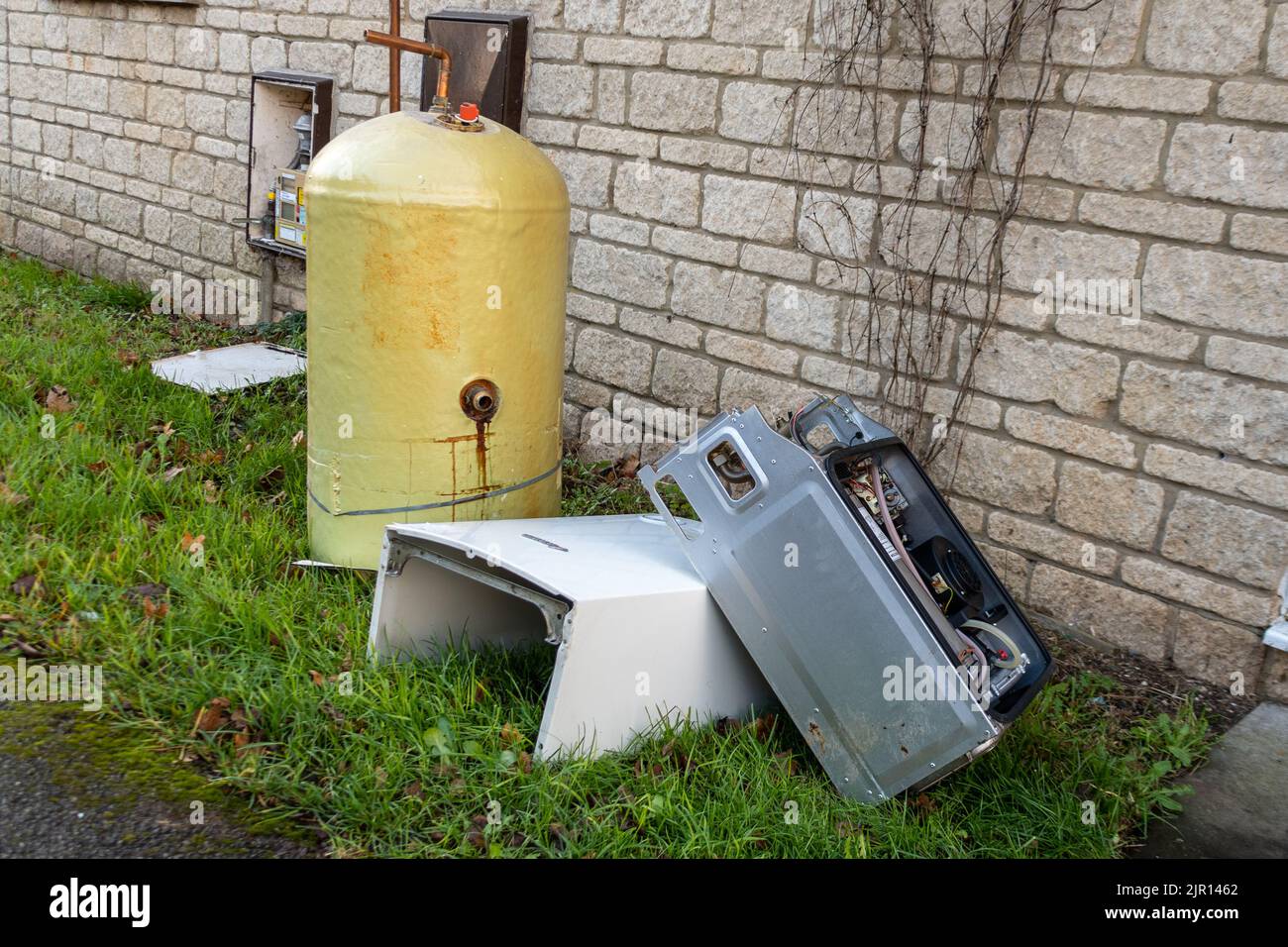An old discarded hot water tank and gas boiler waiting to be collected ...