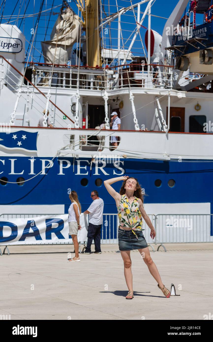 Woman posing in front of the Royal Clipper ship in Port of Zadar, in ...