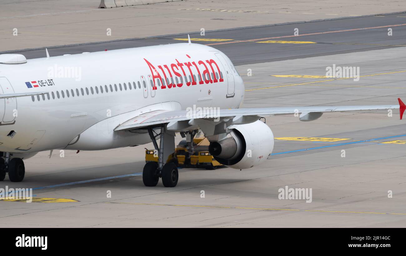 Airport Ground Staff With Pushback Tractor Towing Airplane To Runway ...