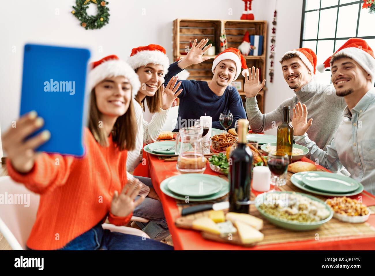 Group of young people having video call using laptop on christmas ...