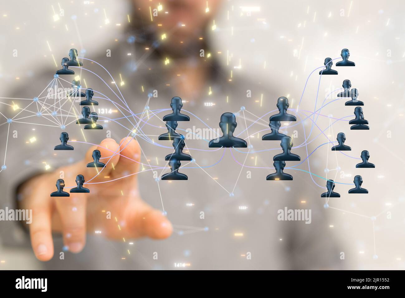 A man tapping a floating 3D-rendered human icons Stock Photo - Alamy