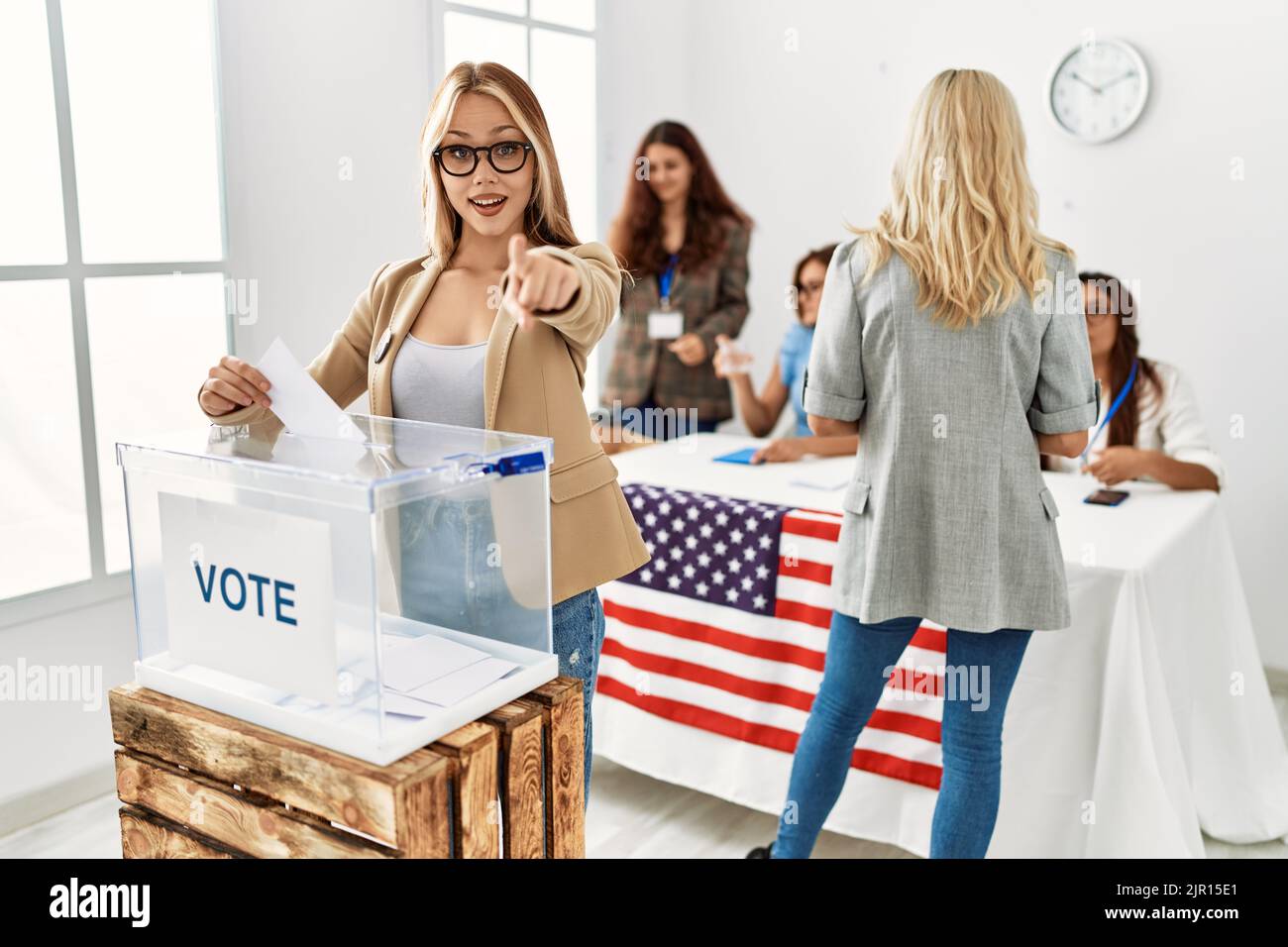 Group of young girls voting at democracy referendum pointing to you and ...