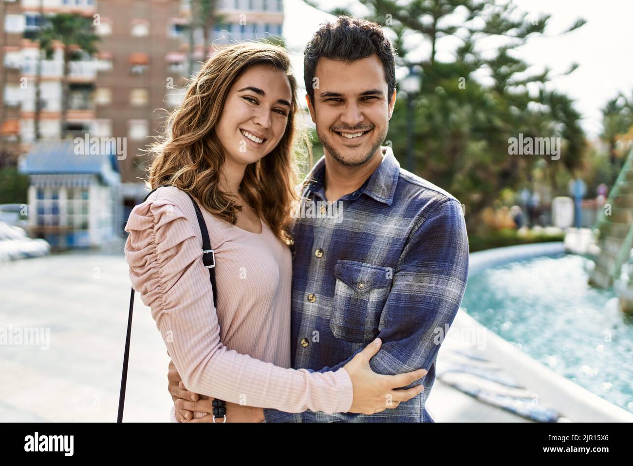 Young hispanic couple hugging in love at the city. Girlfriend and ...
