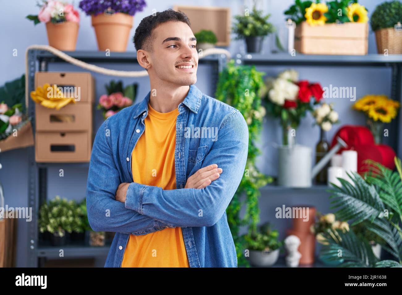 Young hispanic man florist smiling confident standing with arms crossed ...
