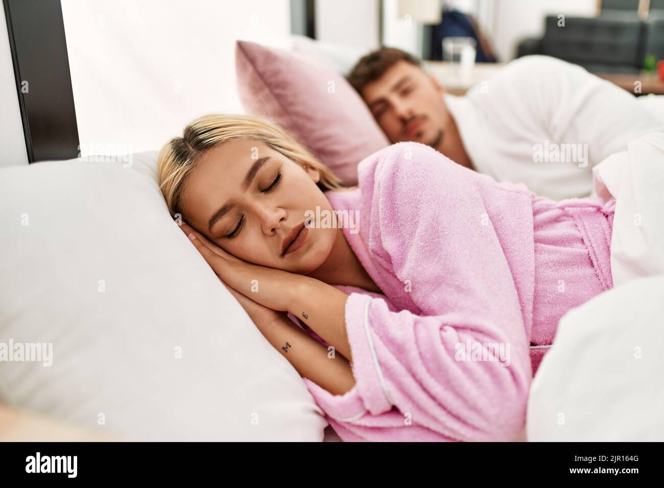 Young caucasian couple sleeping lying on the bed at home Stock Photo ...