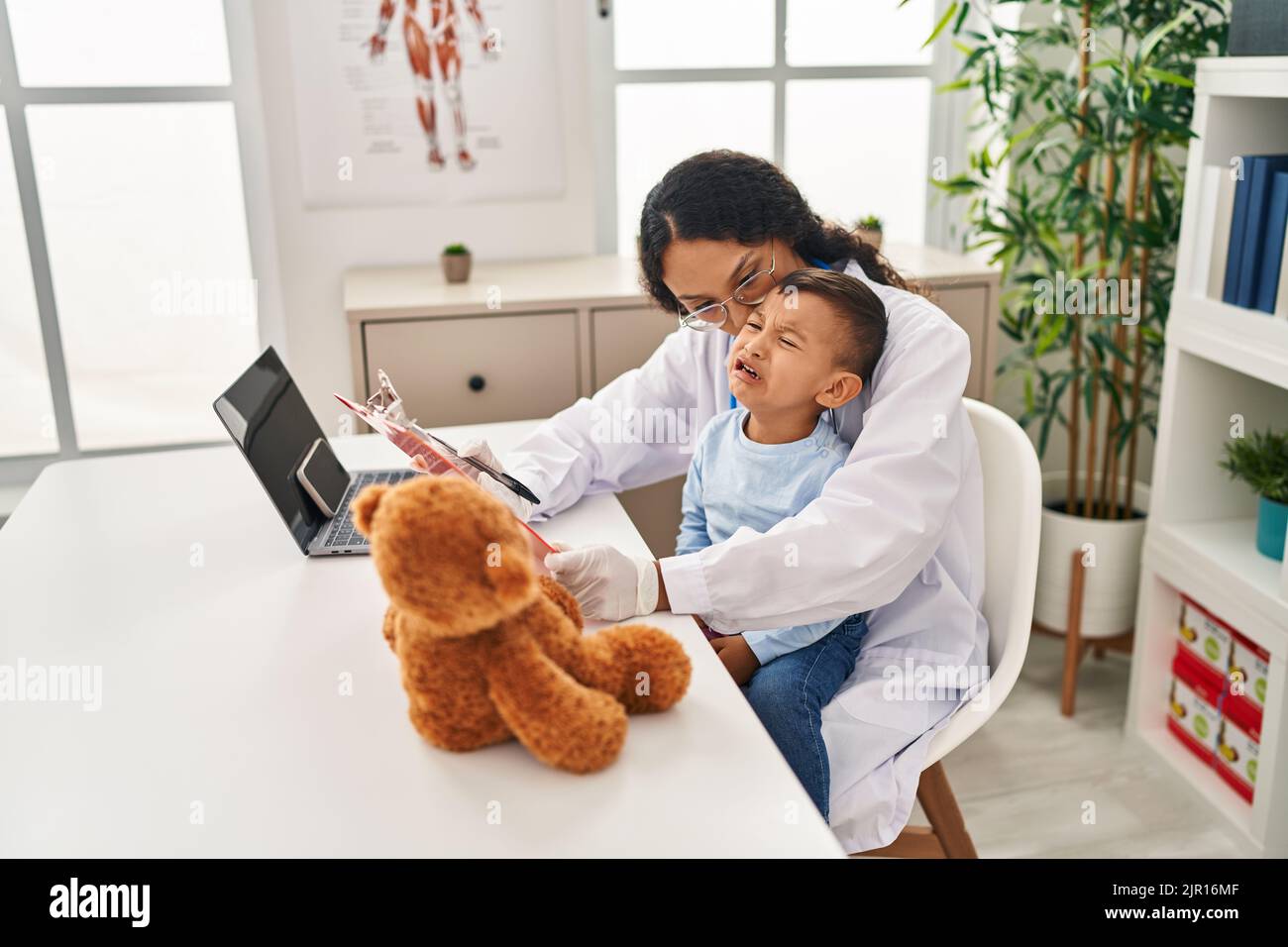 Mother and son pediatrician and patient having medical consultation at ... Mother and son pediatrician and patient having medical consultation at ...