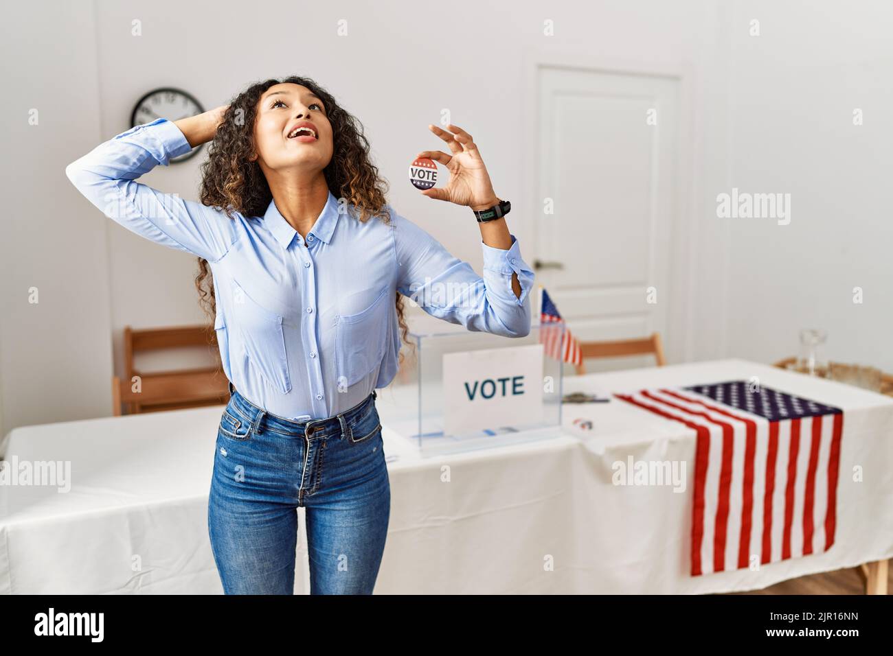 Beautiful hispanic woman standing by at political campaign by voting ...