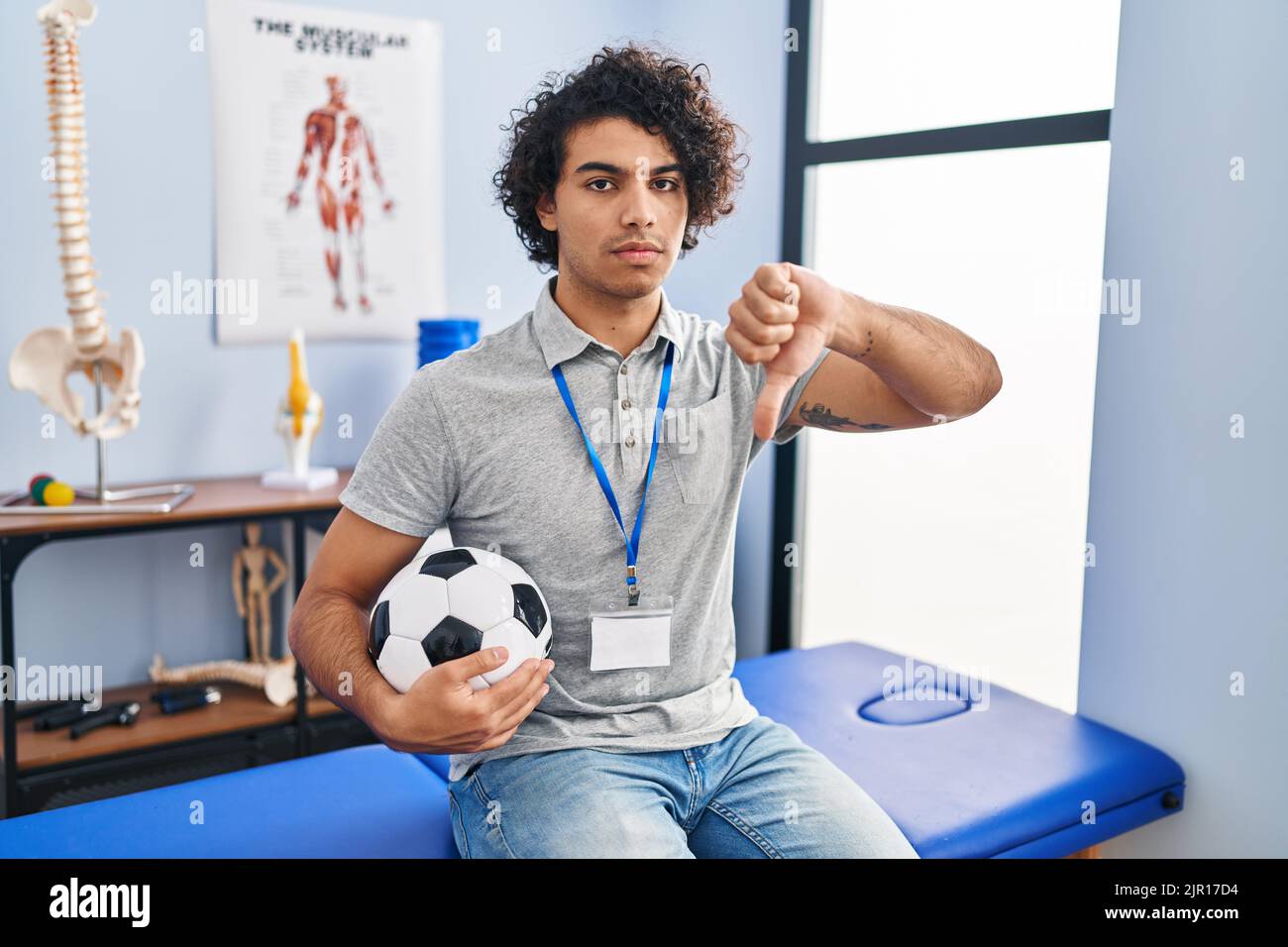 Hispanic man with curly hair working as football physiotherapist ...