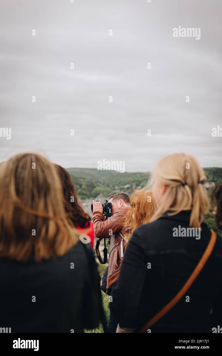 A vertical shallow focus shot of male photograph taking a picture ...