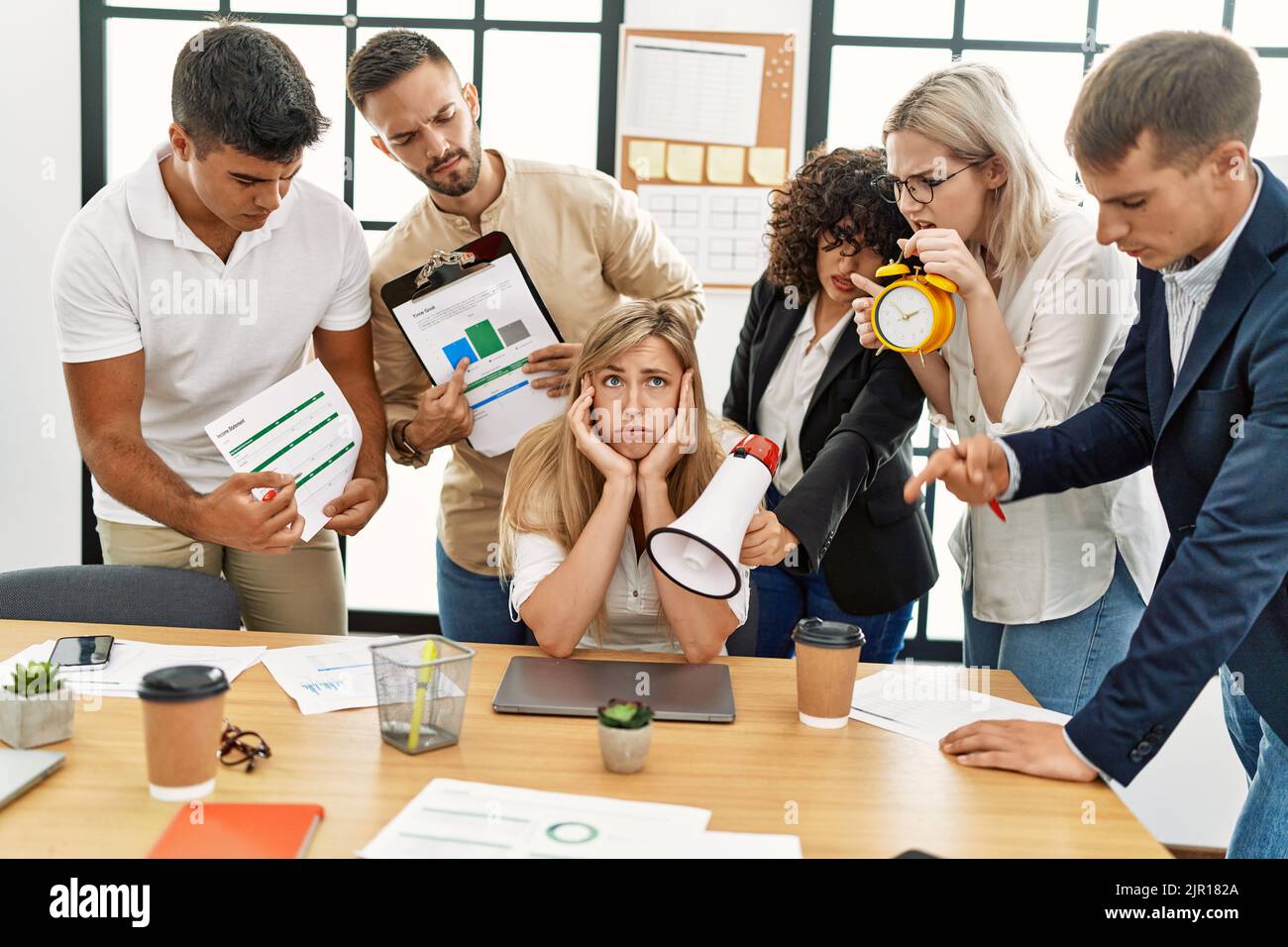 Group of business workers screaming to stressed partner at the office ...