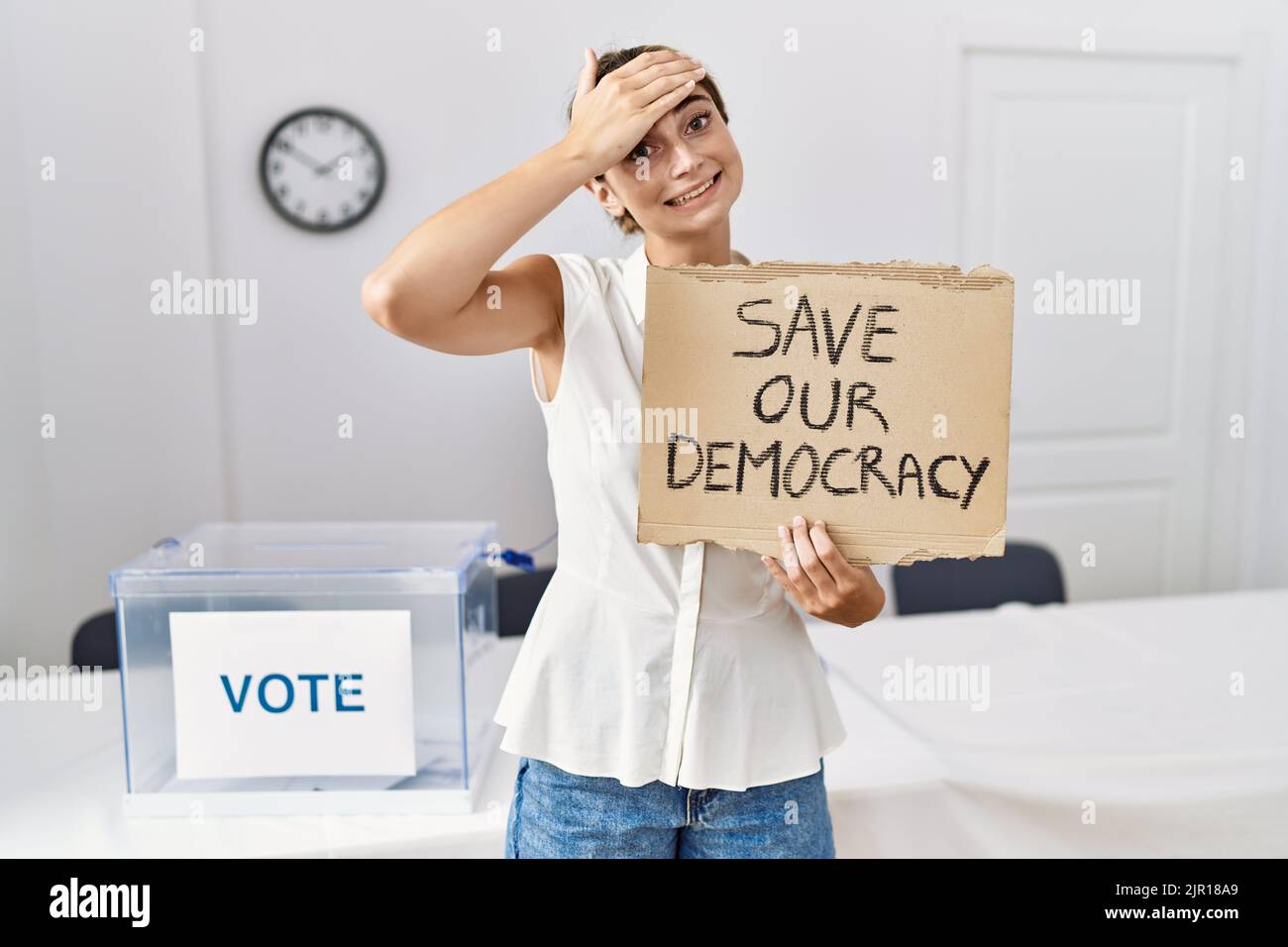 Young blonde woman at political election holding save out democracy ...