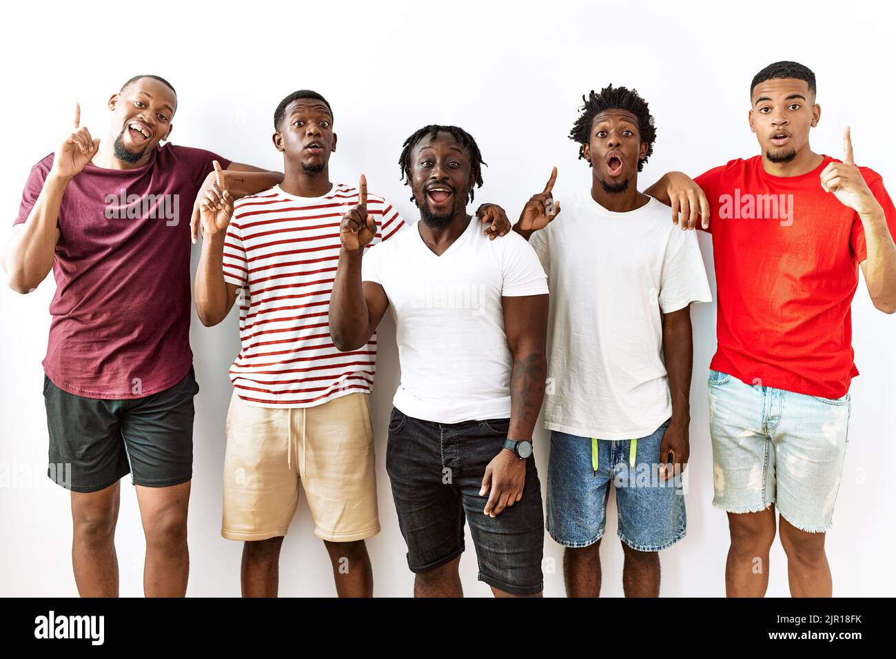Young african group of friends standing together over isolated ...